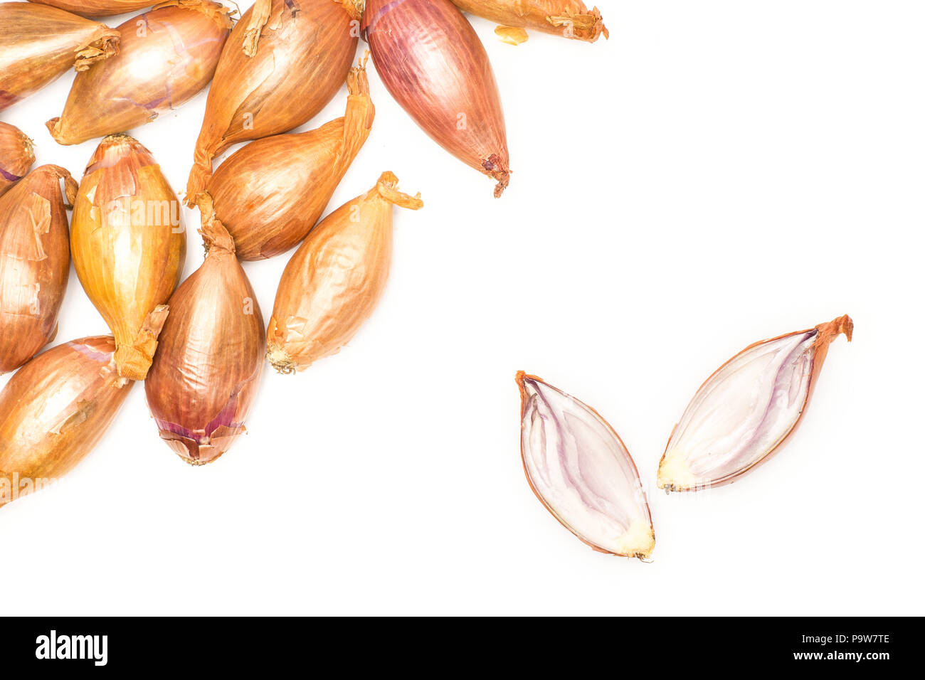 Long golden shallots one cut in two halves flatlay isolated on white ...