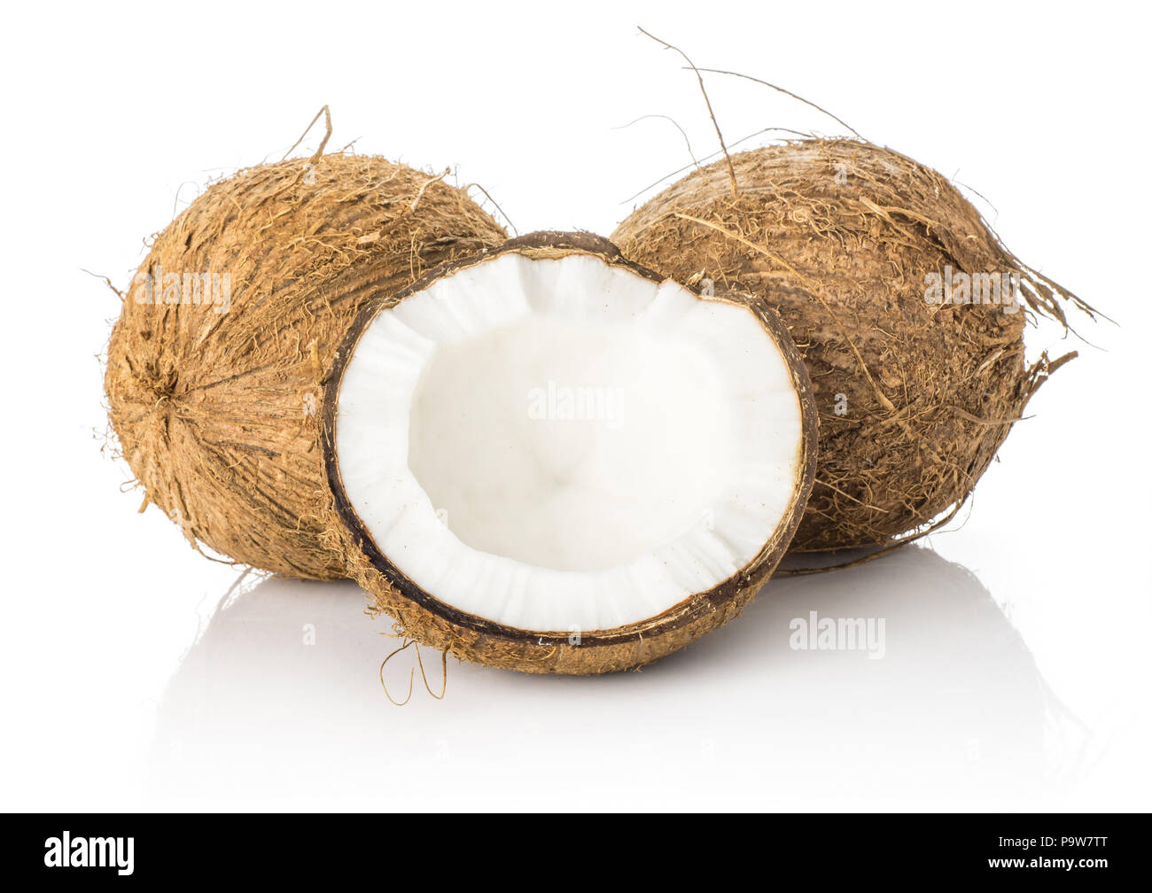 Two coconuts with one half isolated on white background brown fibrous ...