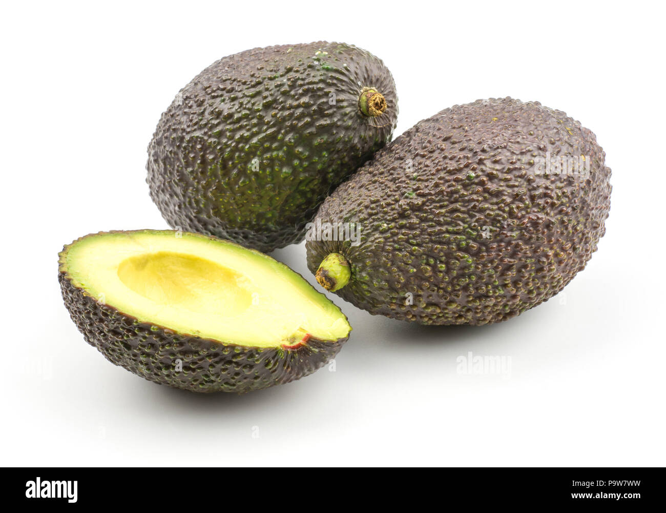 Two avocado with one half without seed isolated on white background ...