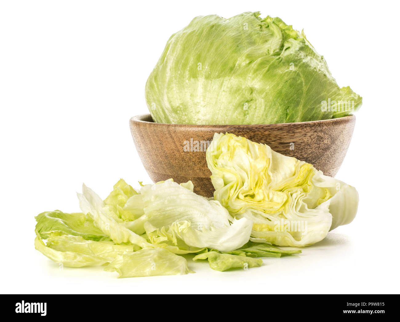 Iceberg lettuce one fresh cabbage head in a wooden bowl with a lot of ...