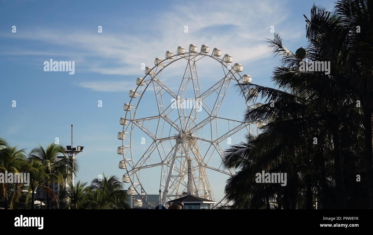 Ferris wheel in Manila, Mall of Asia. Ferris wheel against a blue sky ...