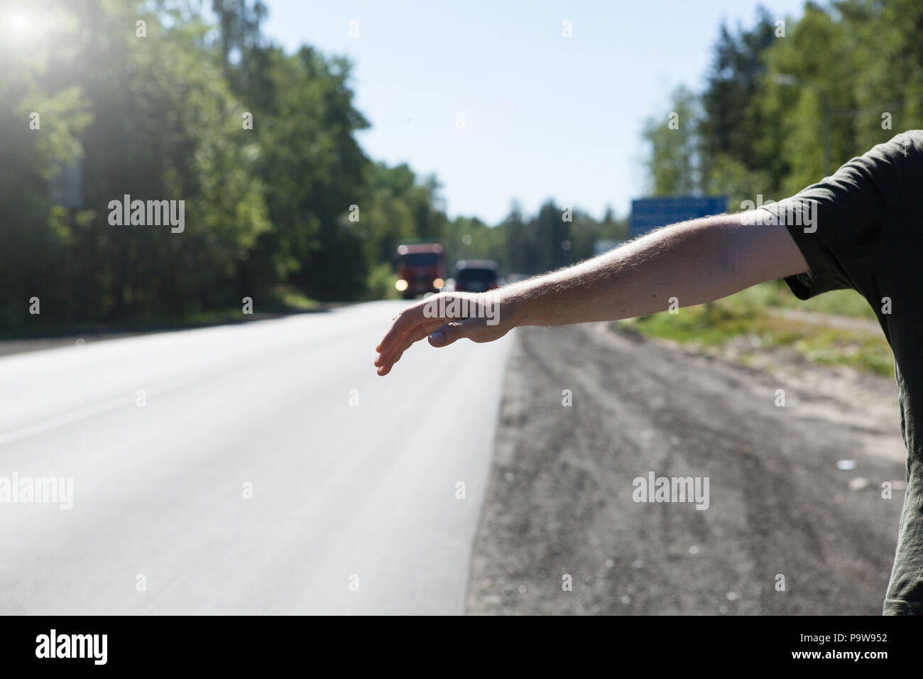 hand of a man is stretched out on the road with a hitchhiker Stock ...