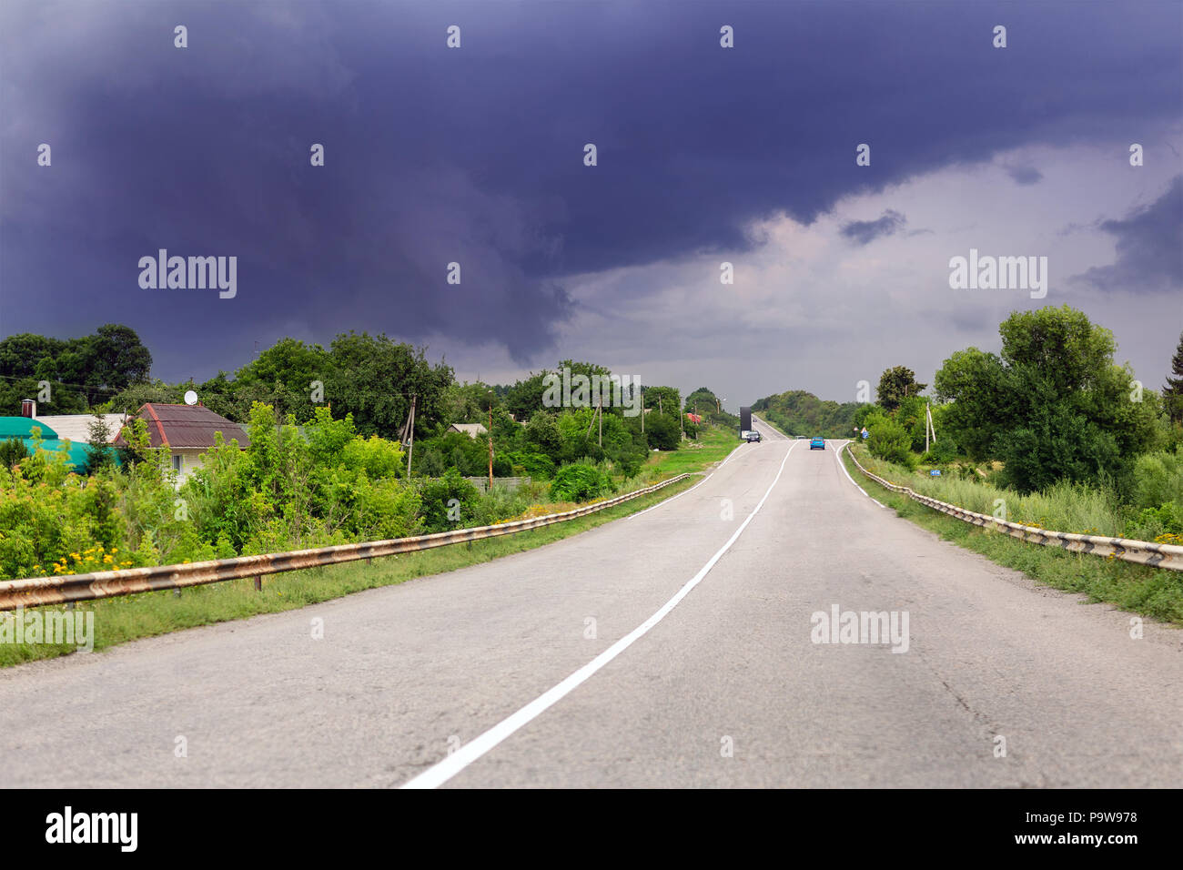 Asphalt highway road and rainy clody dark thunder sky on background ...