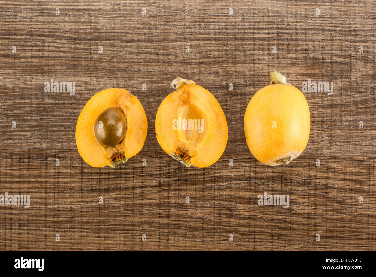 Fresh orange Japanese loquats collection top view isolated on brown ...