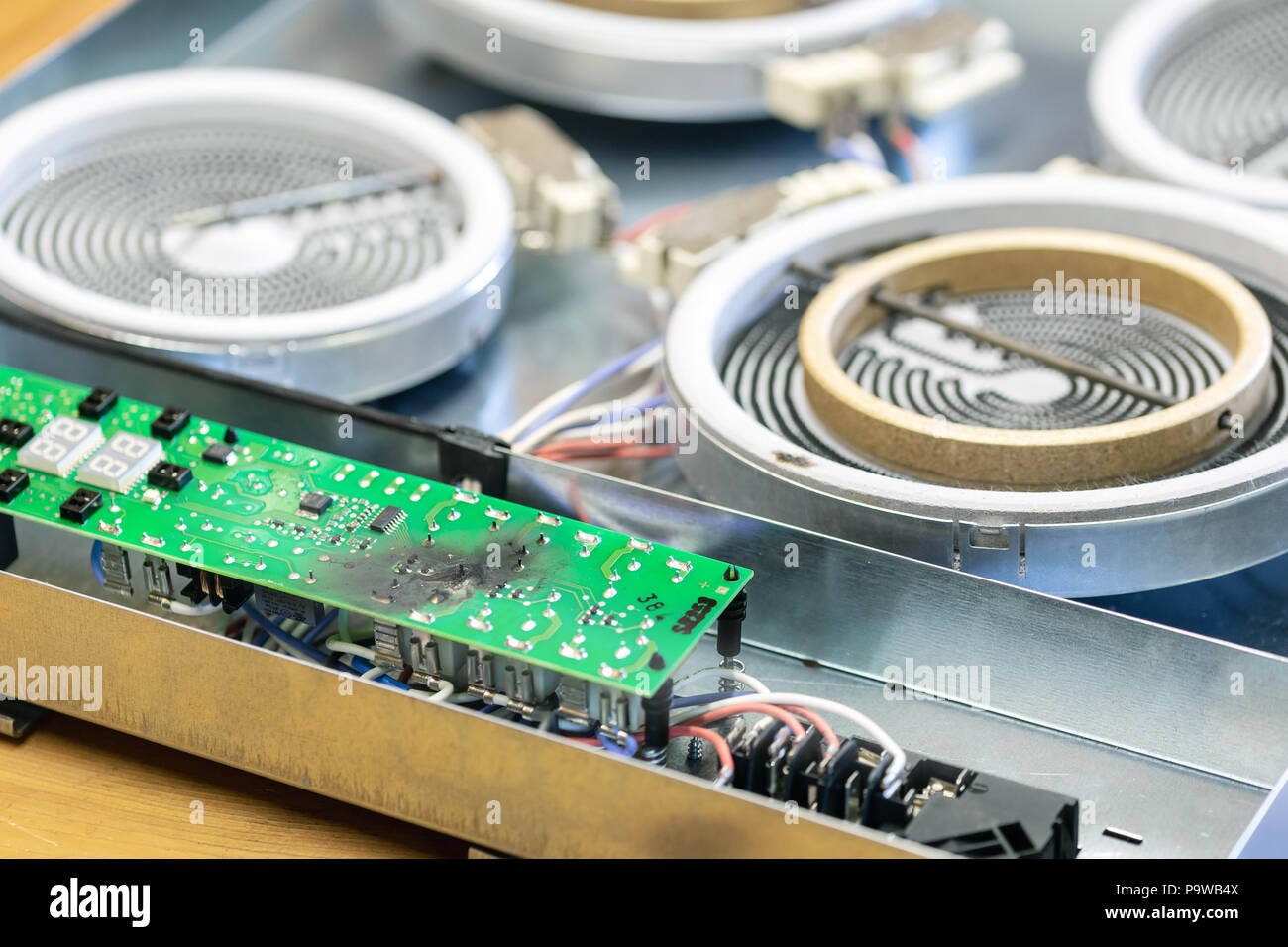 Burnt green microchip after short circuit due to water damage. Damaged ...