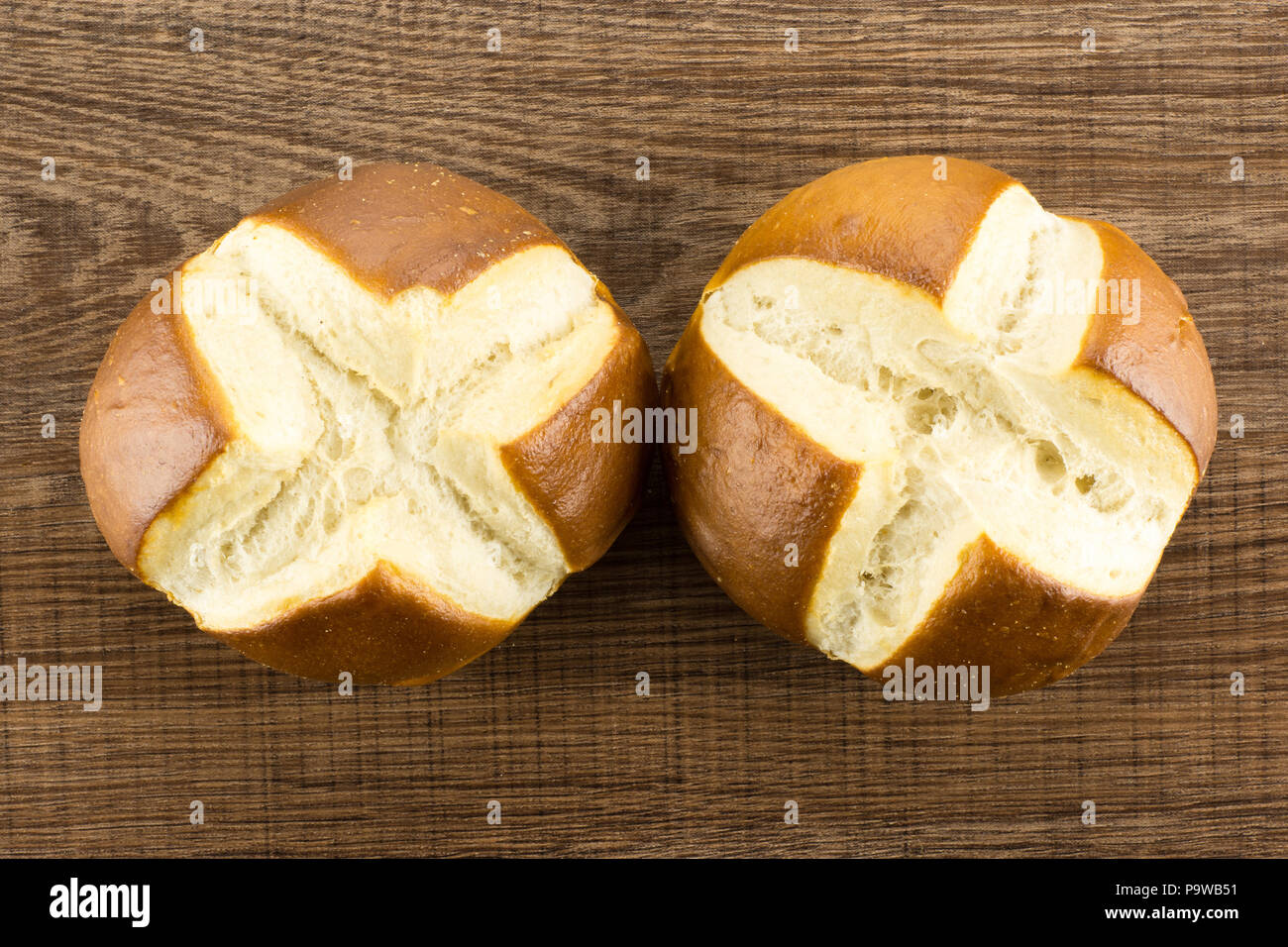 Bavarian bread buns top view on brown wood background two fresh baked ...