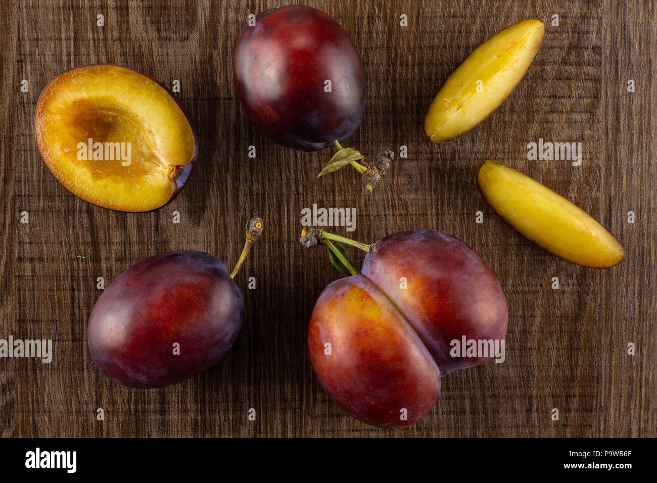 Group of three whole one half two slices of fresh violet-blue plum ...