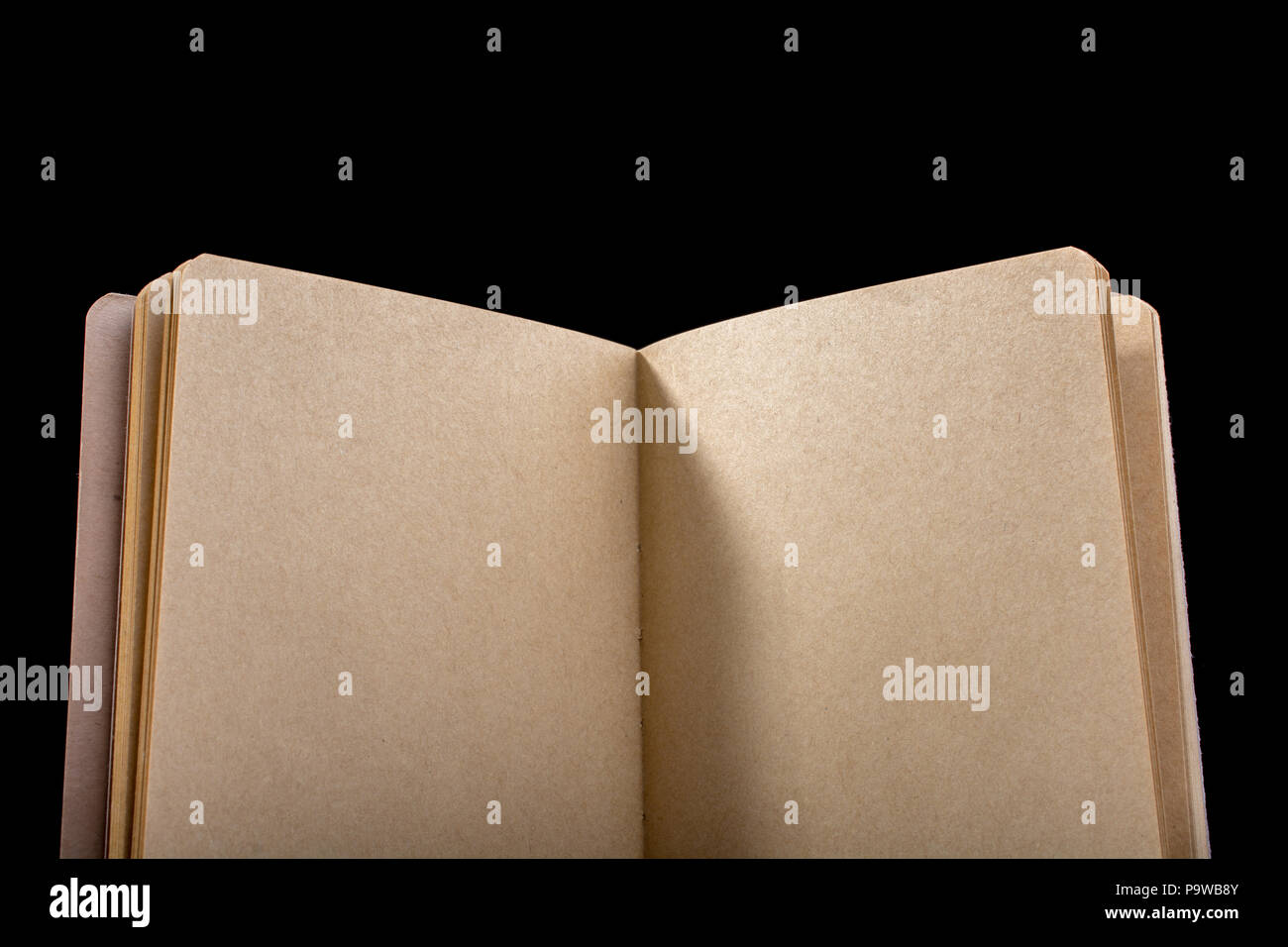 Brown color notebook open on a black background Stock Photo - Alamy