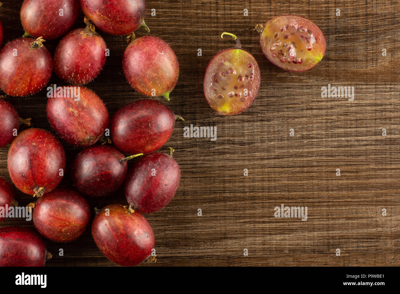 Lot of whole fresh red gooseberry hinnomaki variety one cut in two ...
