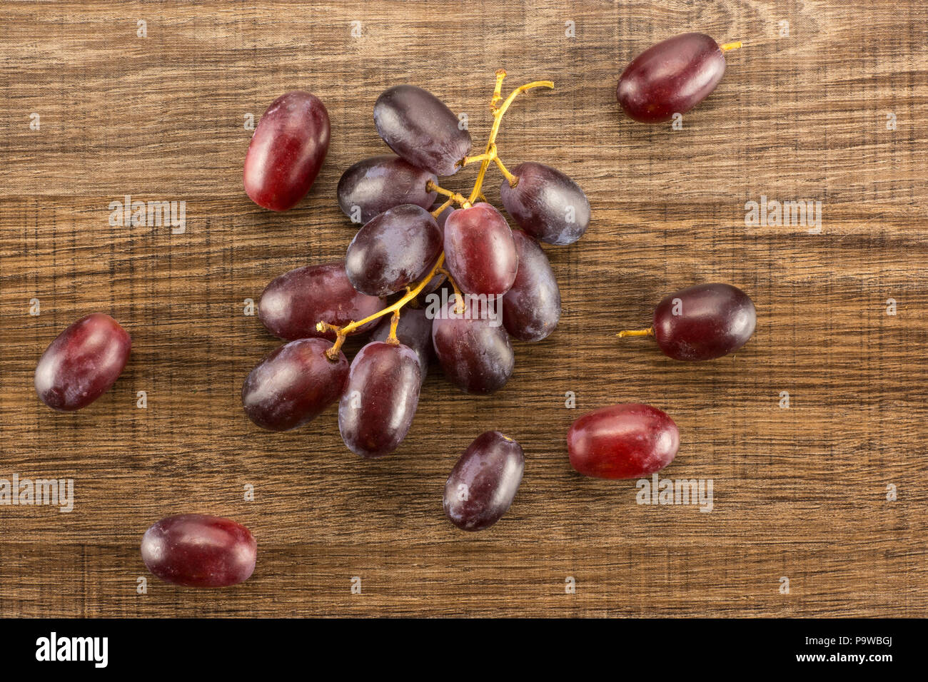 Red globe grape table top isolated on brown wood background dark pink ...