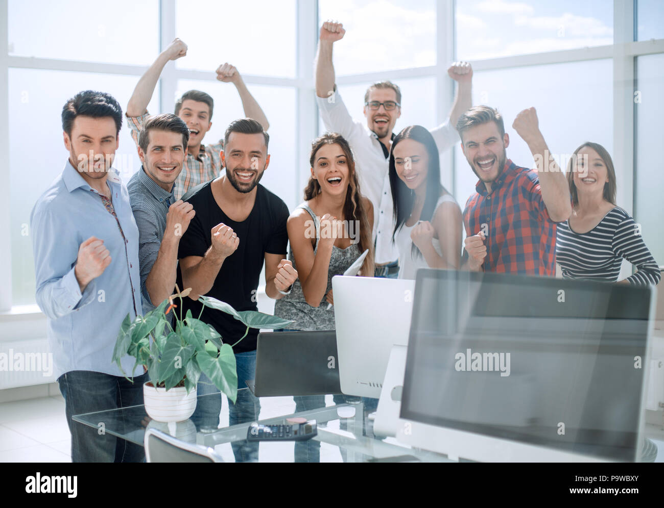 happy business team standing in modern office Stock Photo - Alamy