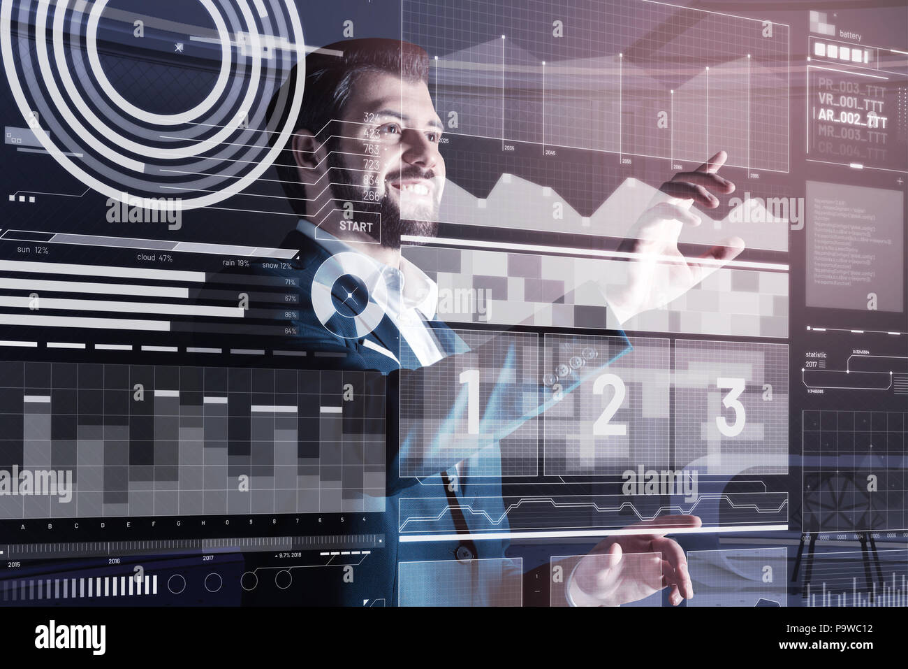 Amazing program. Cheerful hardworking programmer feeling happy and smiling while standing in ...