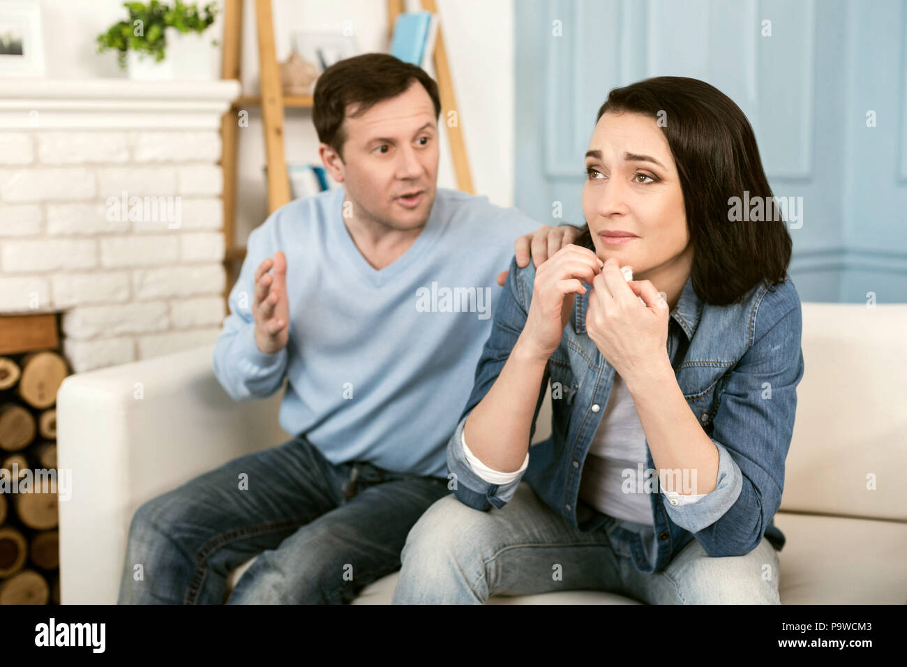Overloaded with problems. Depressed cheerless pleasant woman holding a ...