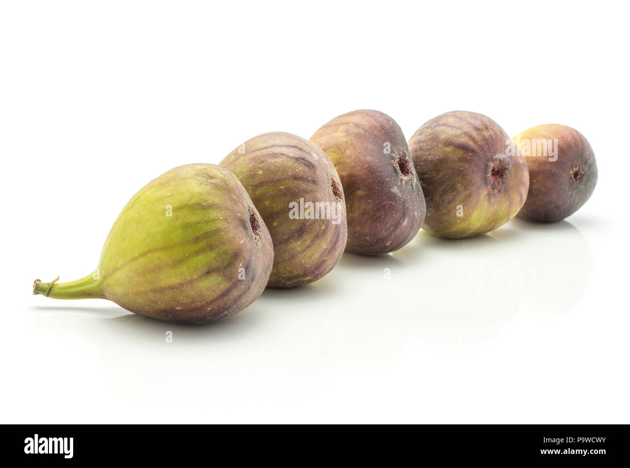 Five figs isolated on white background fresh ripe purple green in row ...