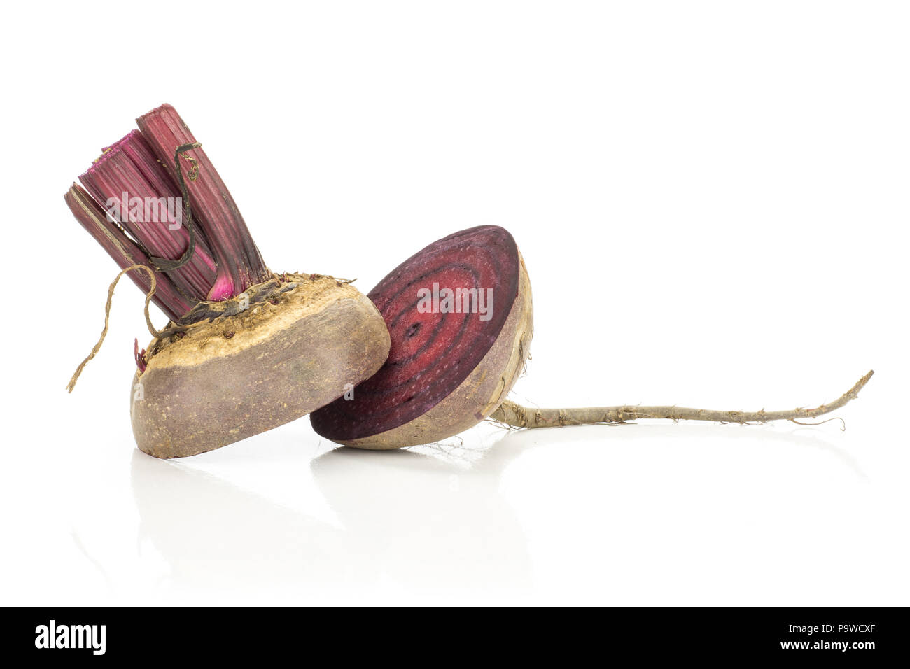 Sliced red beet one cut in two halves isolated on white background ...