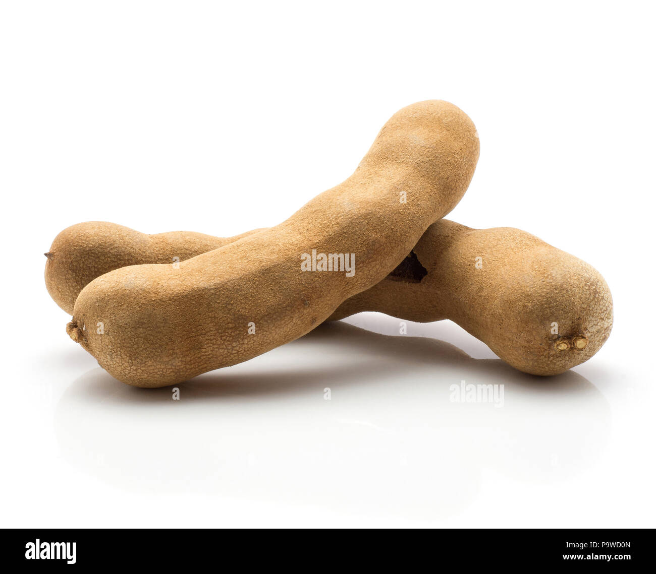 Tamarind isolated on white background two Indian dates in a brown ...