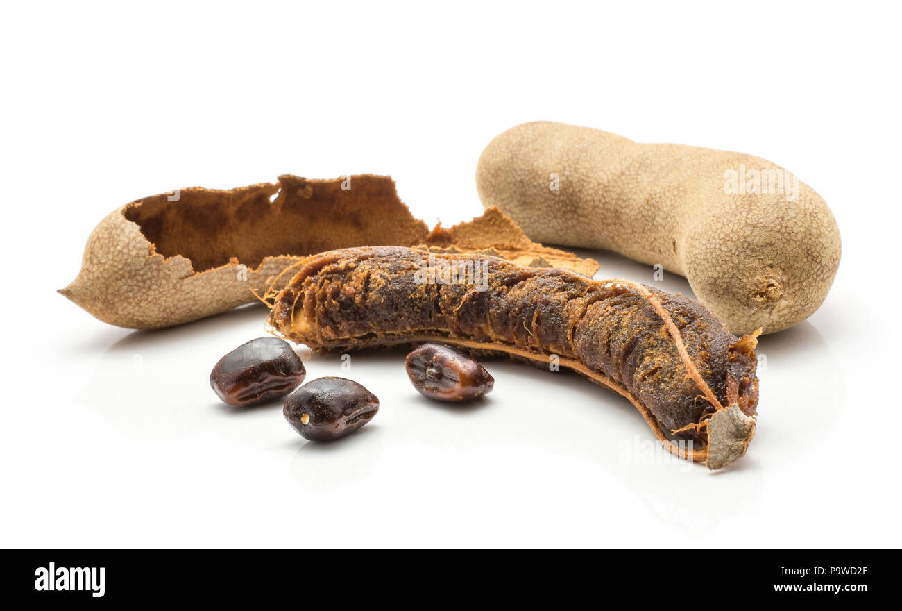 Cracked tamarind jelly flesh out of shell and three seeds isolated on ...