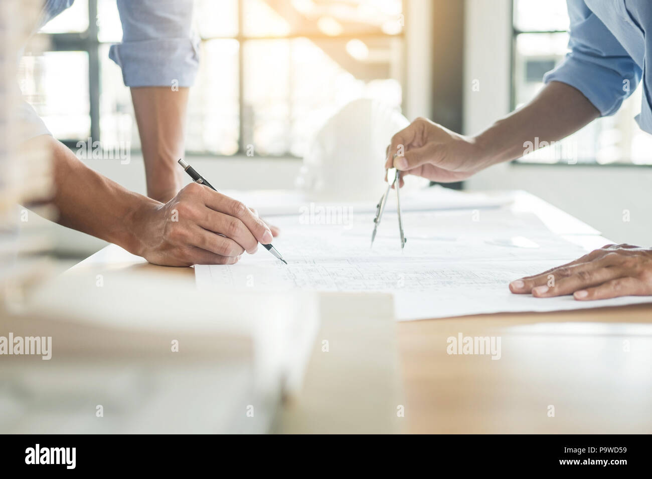 Close-up Of Person's engineer Hand Drawing Plan On Blue Print with ...