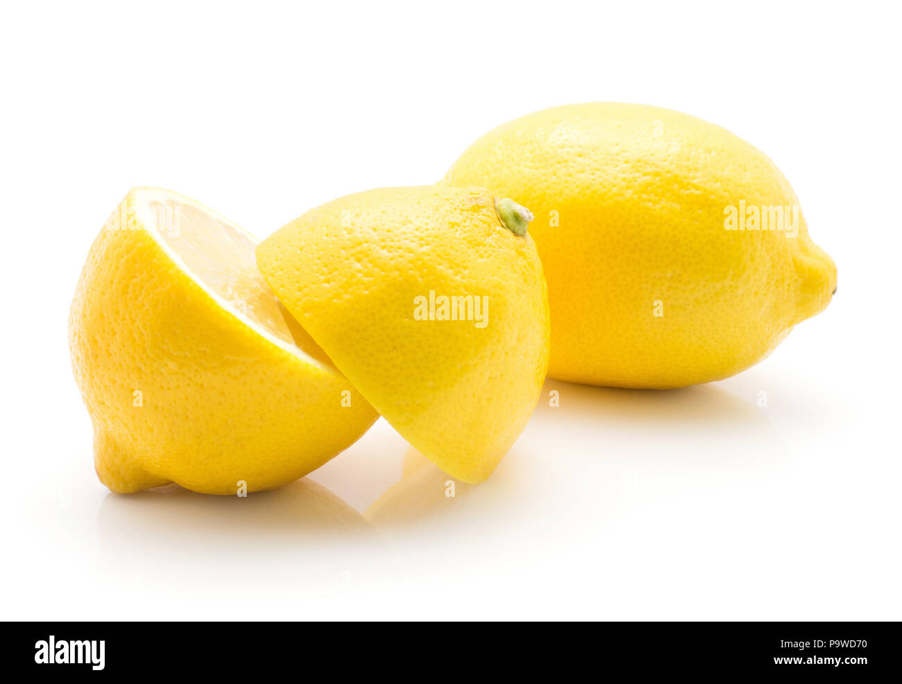 One sliced lemon and one whole yellow isolated on white background ...