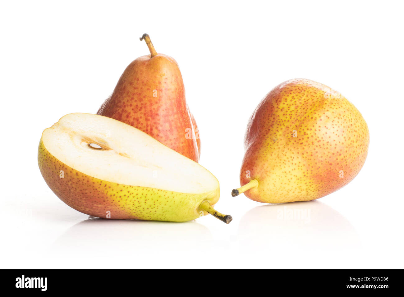 Group of two whole one half of fresh red pear forelle variety isolated ...