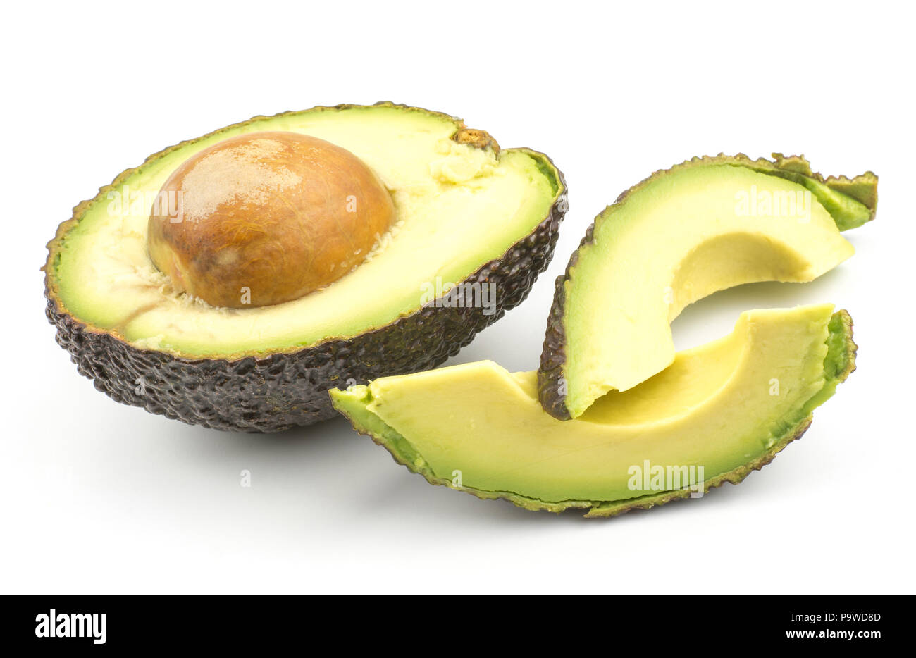 Avocado two fresh cut slices and one half with a seed isolated on white ...