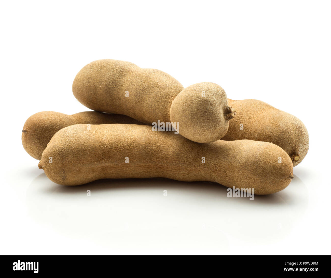 Tamarind isolated on white background three Indian dates in a brown ...