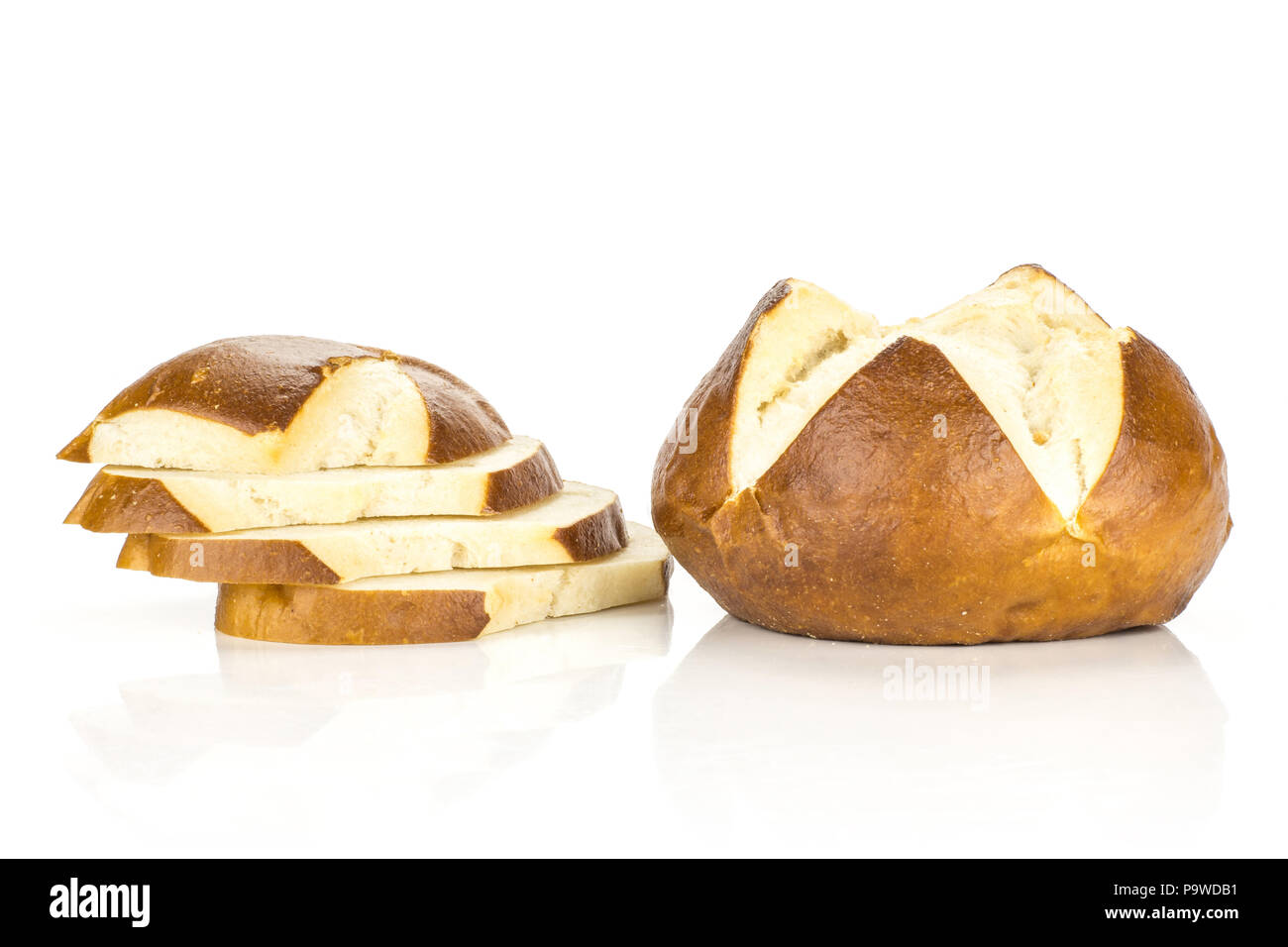 One Bavarian bread bun and four sliced pieces isolated on white ...