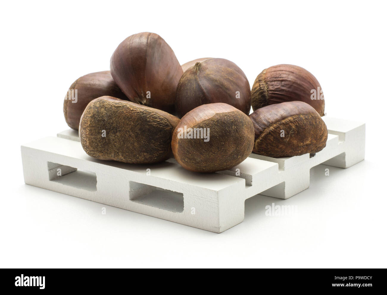 European chestnuts Spanish edible on a pallet isolated on white ...