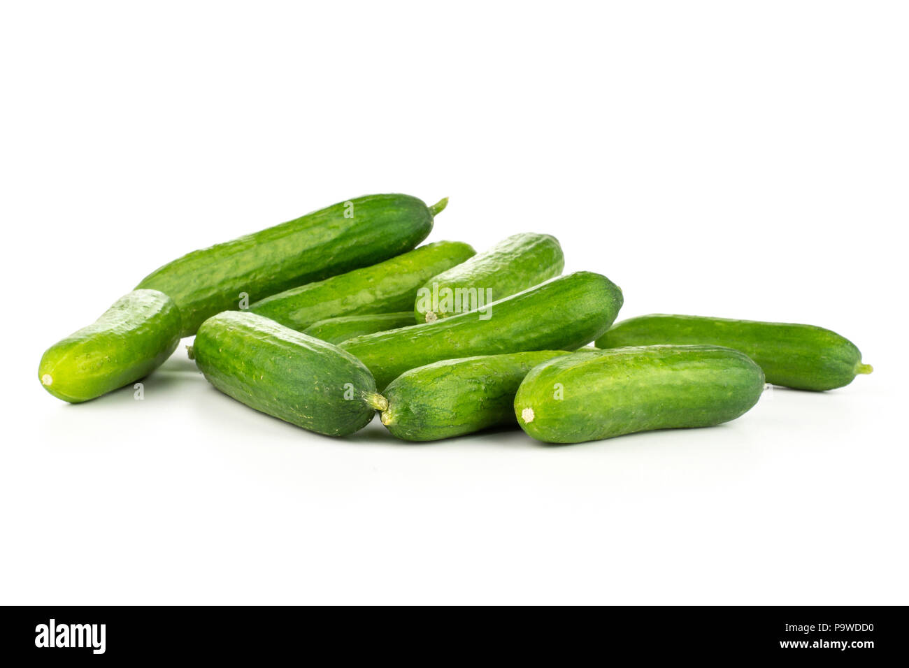 Fresh green mini cucumbers heap isolated on white background Stock ...