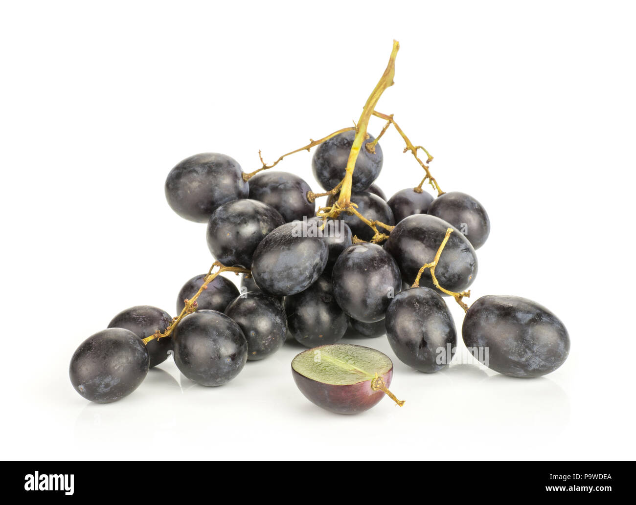 Black grape cluster (autumn royal variety) with one sliced half ...