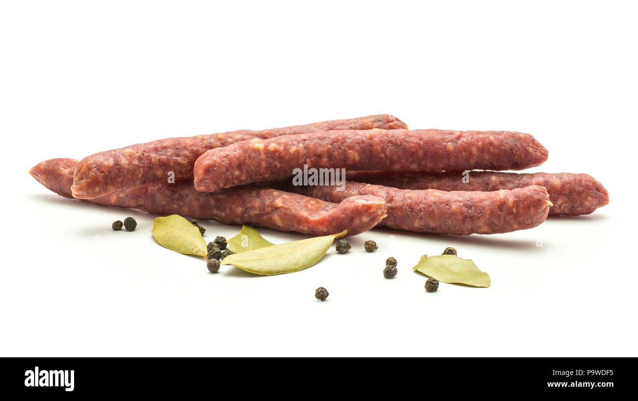 Hungarian dry sausages pepperoni stack with black pepper and bay leaves ...