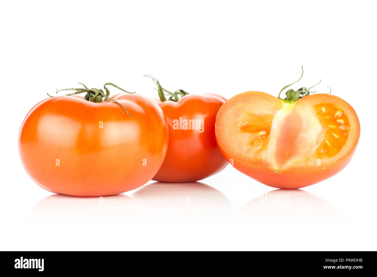 Two red tomato and one sliced half isolated on white background Stock ...