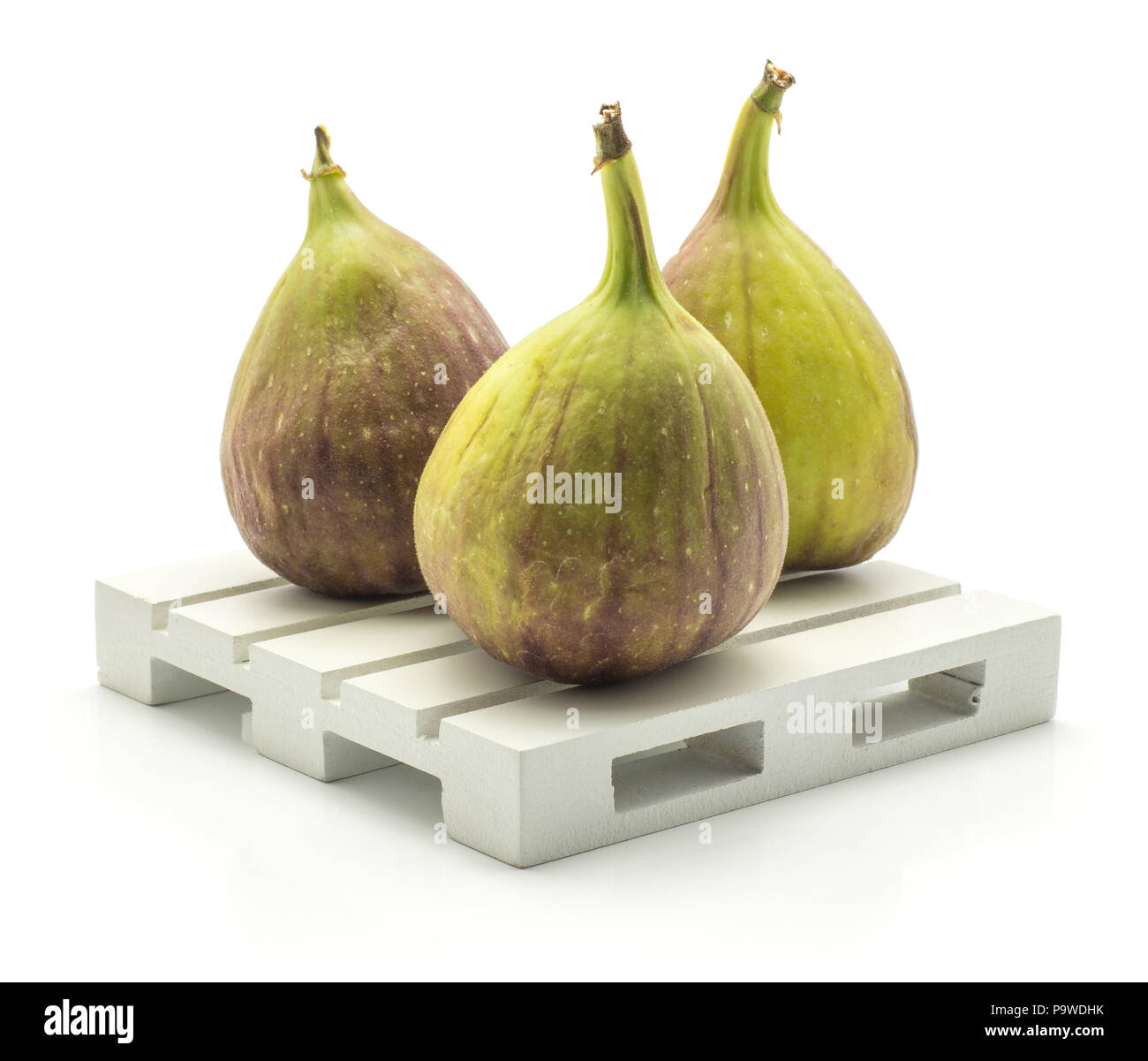 Three fresh figs on a pallet isolated on white background ripe purple ...