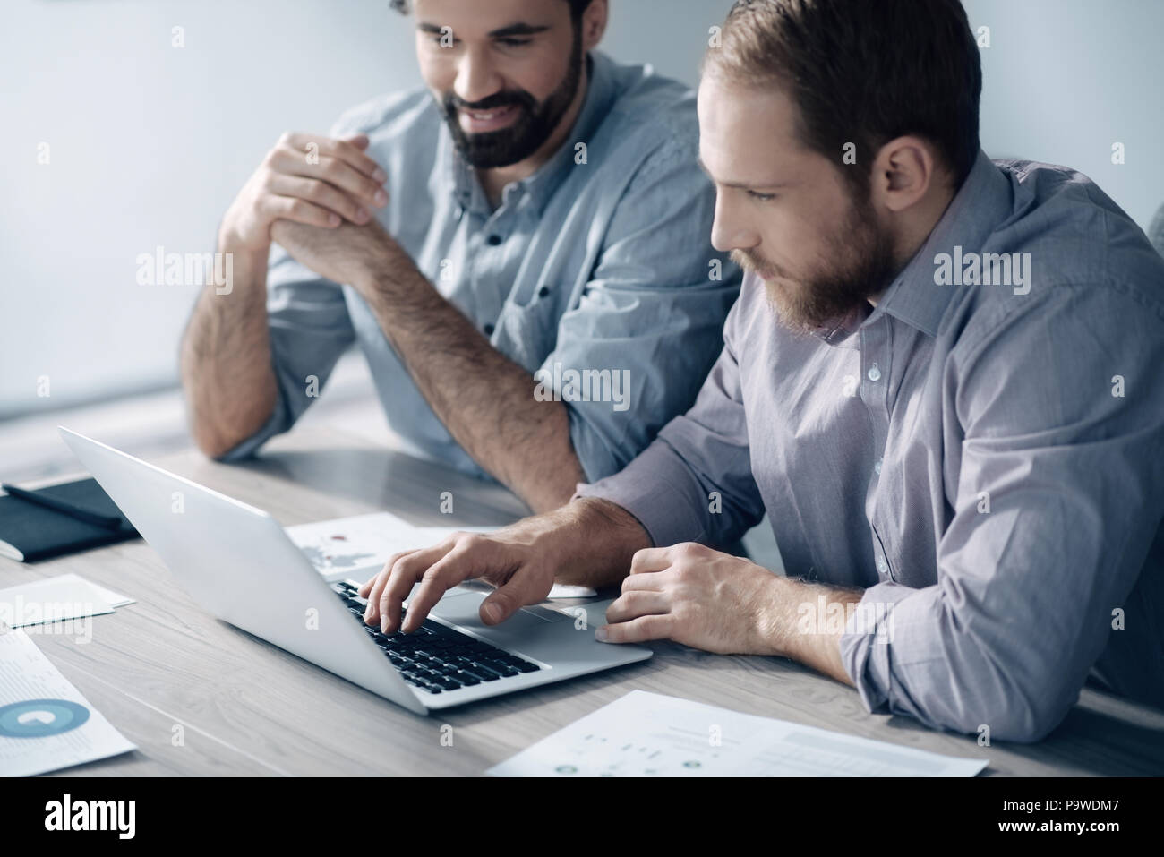 Internet users, Pleasant enthusiastic man sitting in the office and ...