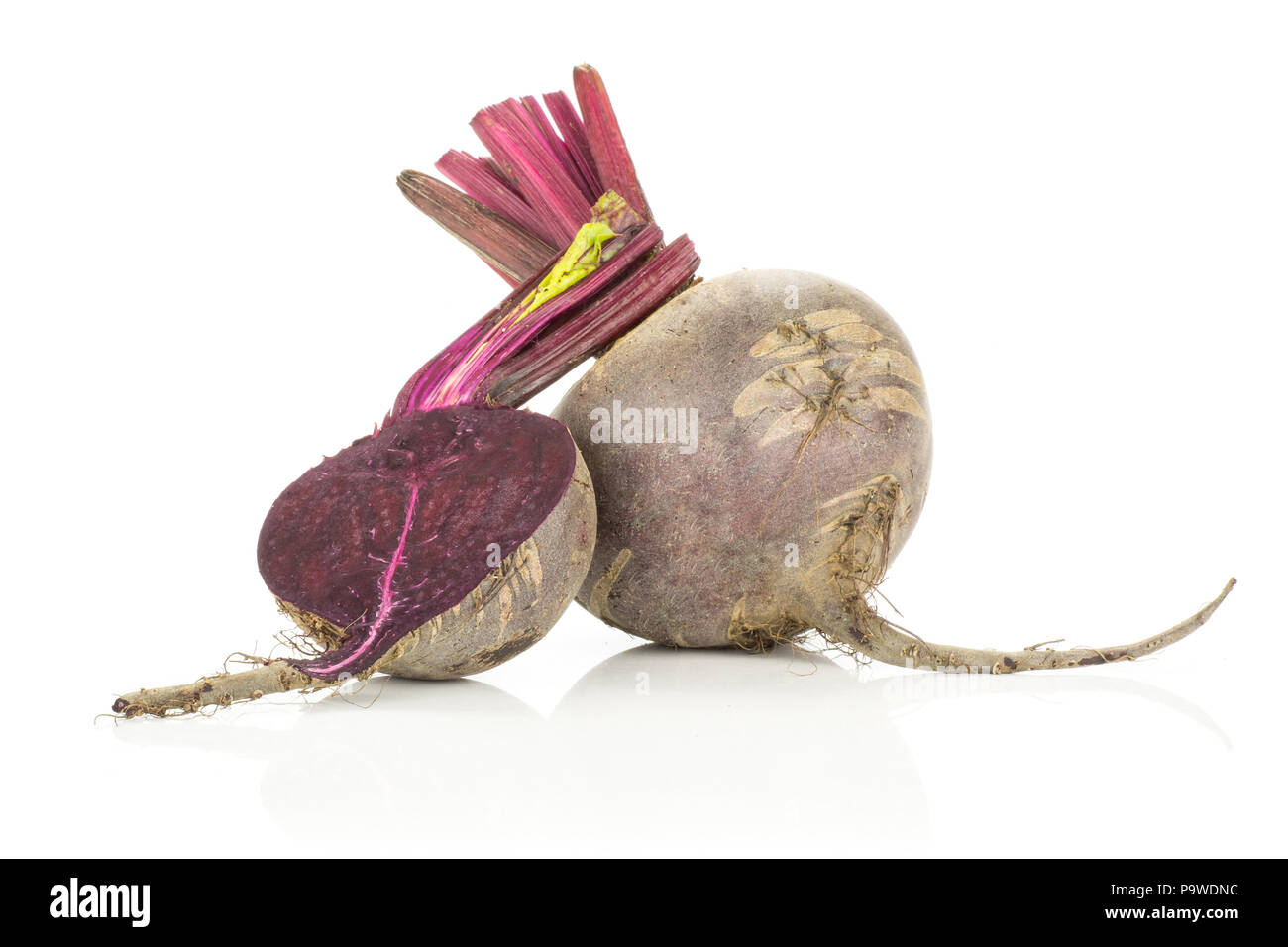 One red beet with section half young bulbs isolated on white background ...