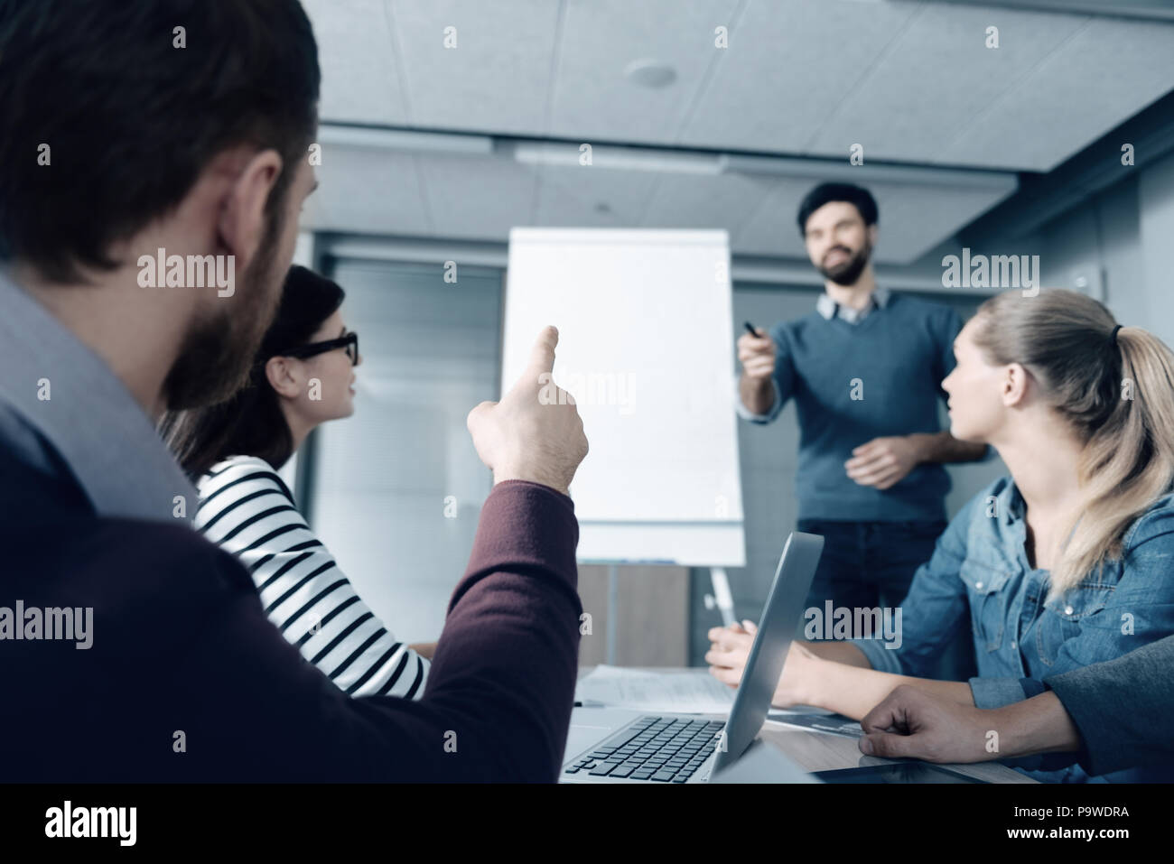 Curiosity wins. Close up of a pleasant man asking questions while a ...