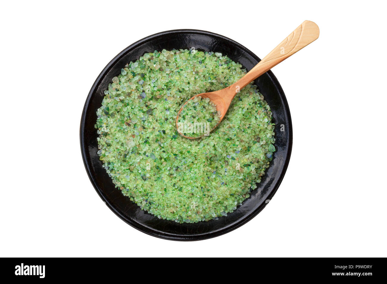 green sea salt for bath with pine extract in round black wooden plate ...