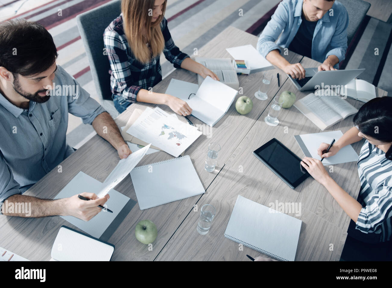 Group creativity. Top view of young diligent people sitting in the ...