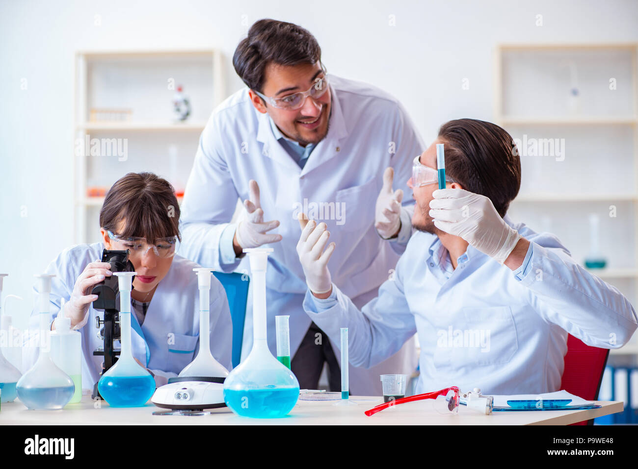 Team of chemists working in the lab Stock Photo - Alamy