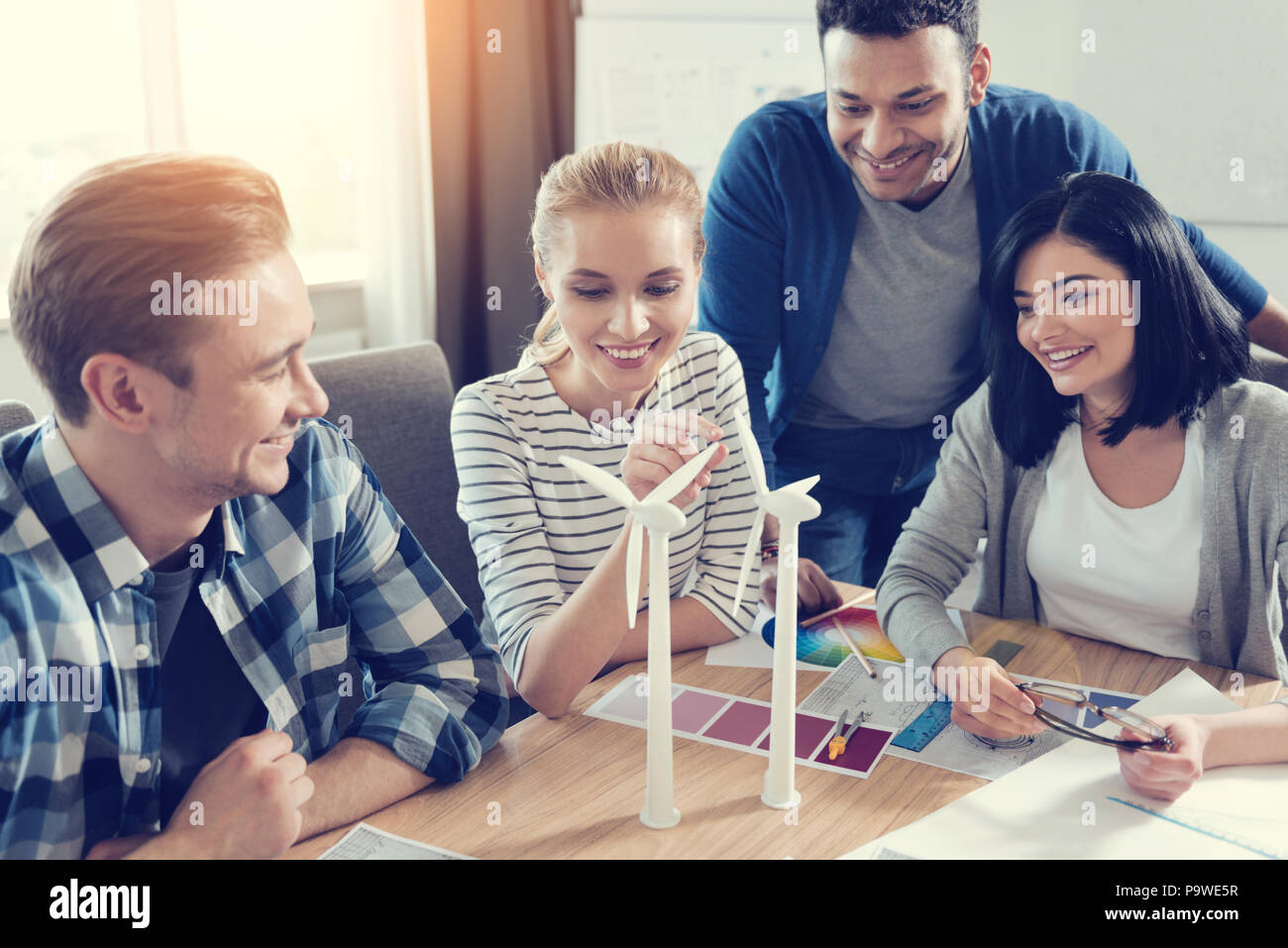 Our project. Group of positive people that siting at workplace and ...