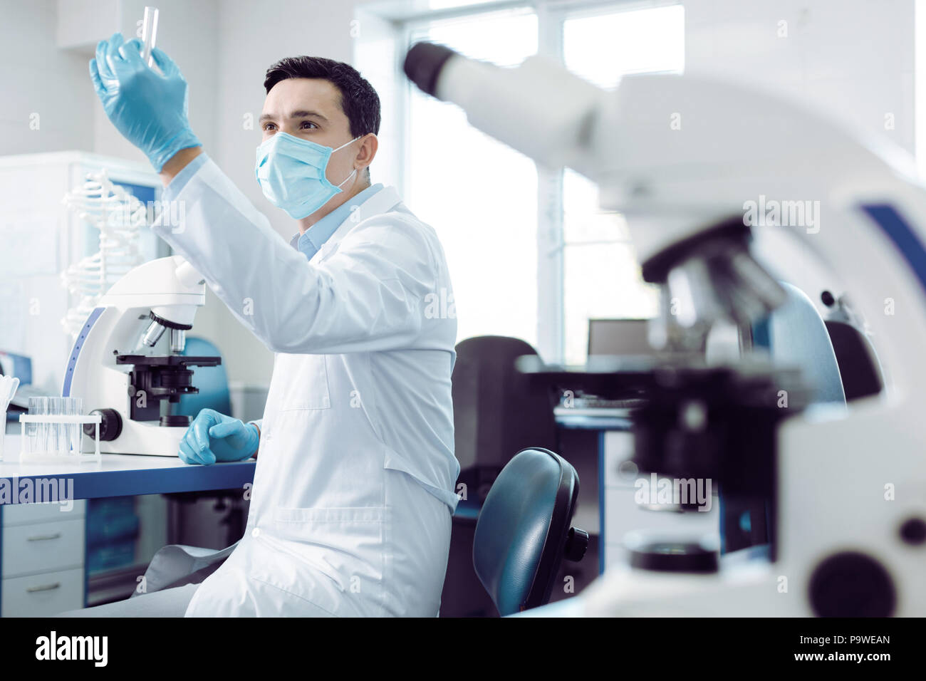 Pleasant scientist holding test hi-res stock photography and images - Alamy