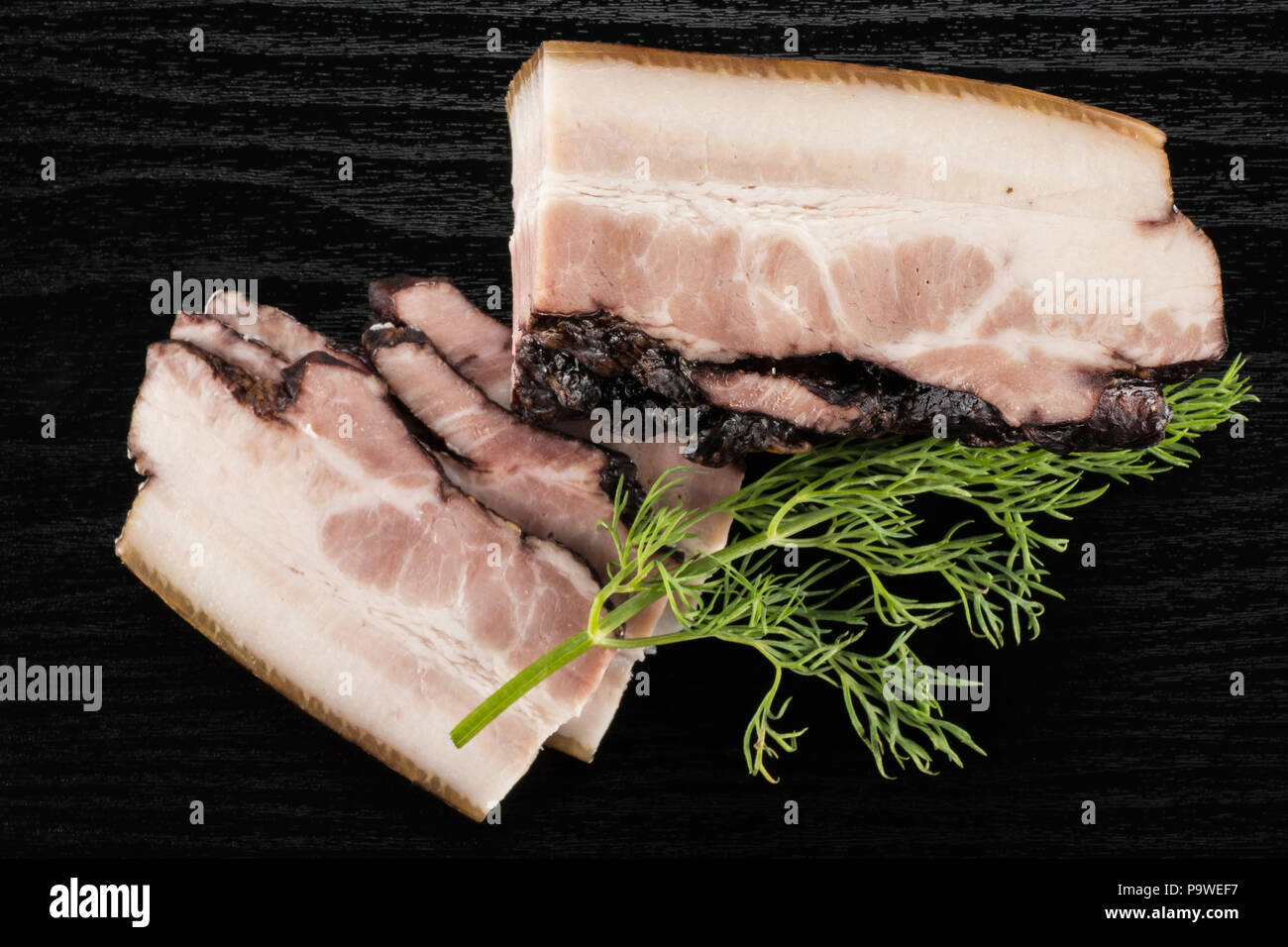 Group of three slices one piece of english bacon with a sprig of dill ...