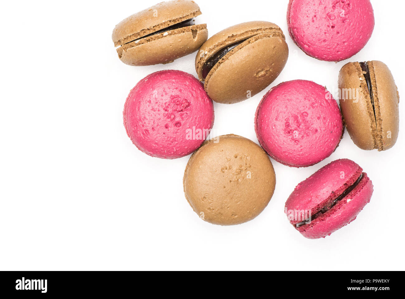 French macarons (brown chocolate, pink raspberry) top view isolated on ...