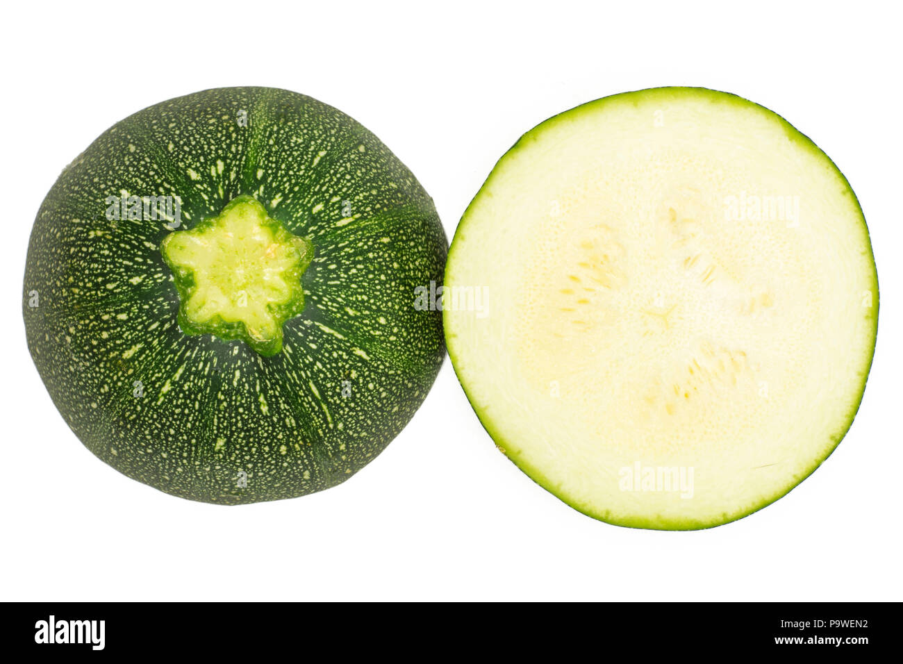 One round zucchini with cross section half flatlay isolated on white ...