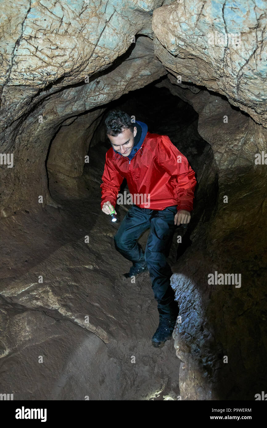 Young boy exploring a cave in a limestone mountain Stock Photo - Alamy