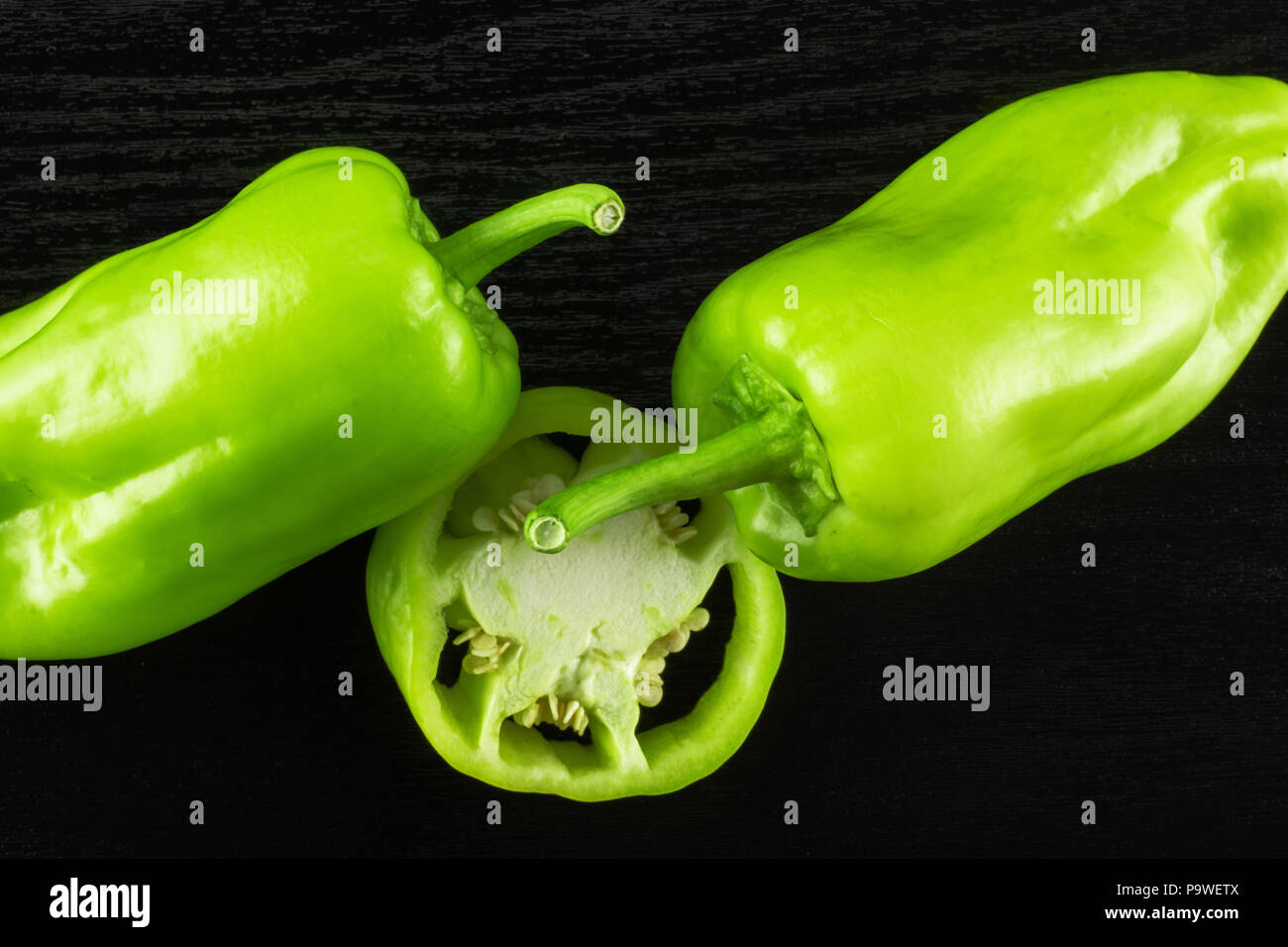 Group of two whole one slice of light green bell pepper flatlay ...
