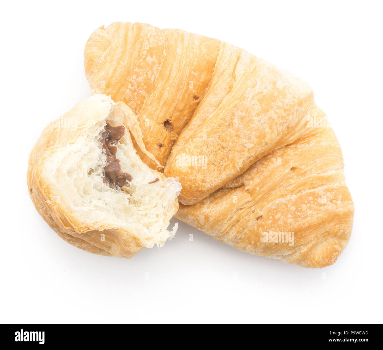 One baked croissant or cornetto with a broken half filled with ...