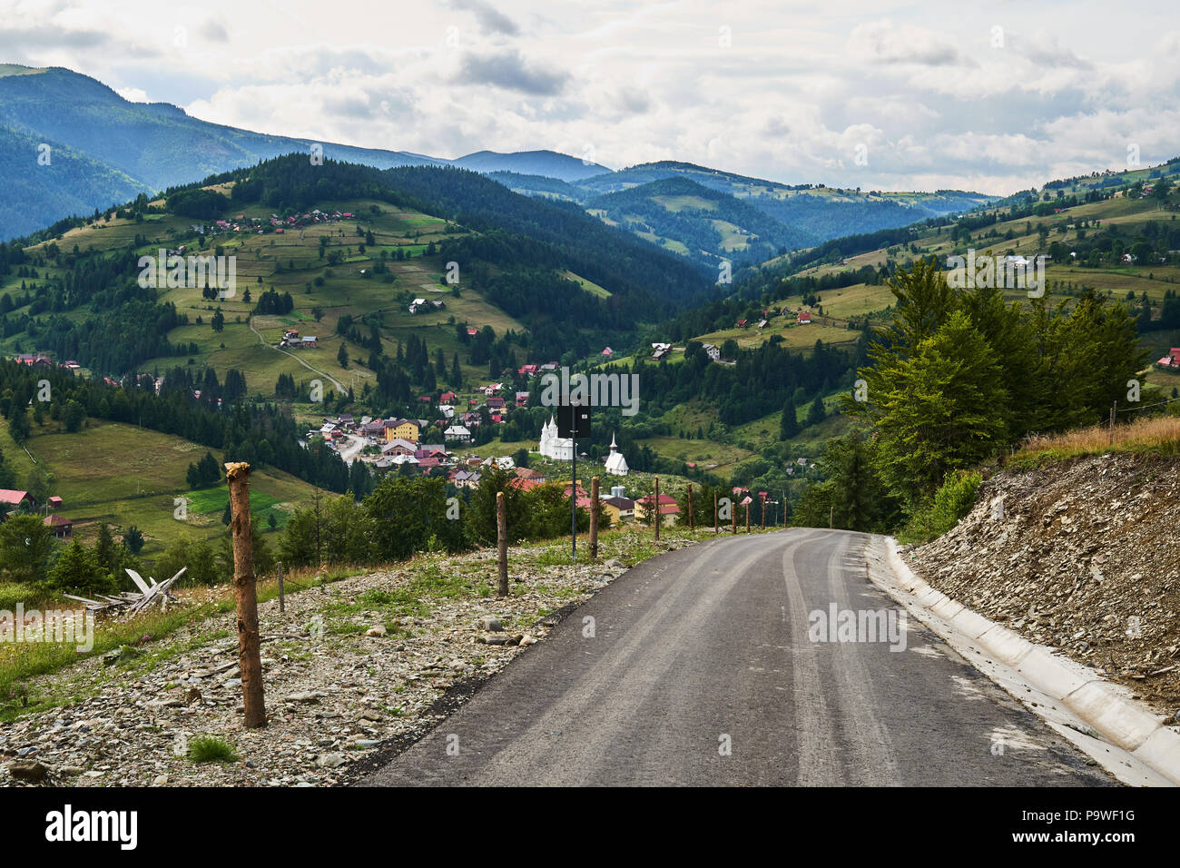 Landscape with an empty road into the mountains Stock Photo - Alamy