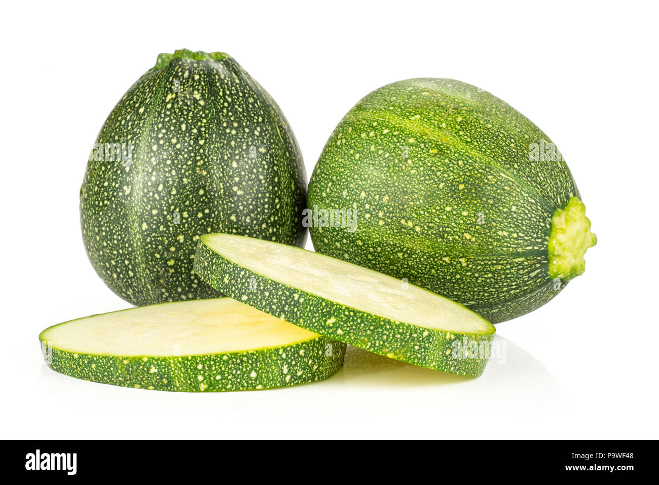 Group of two round zucchini and two slices isolated on white background ...