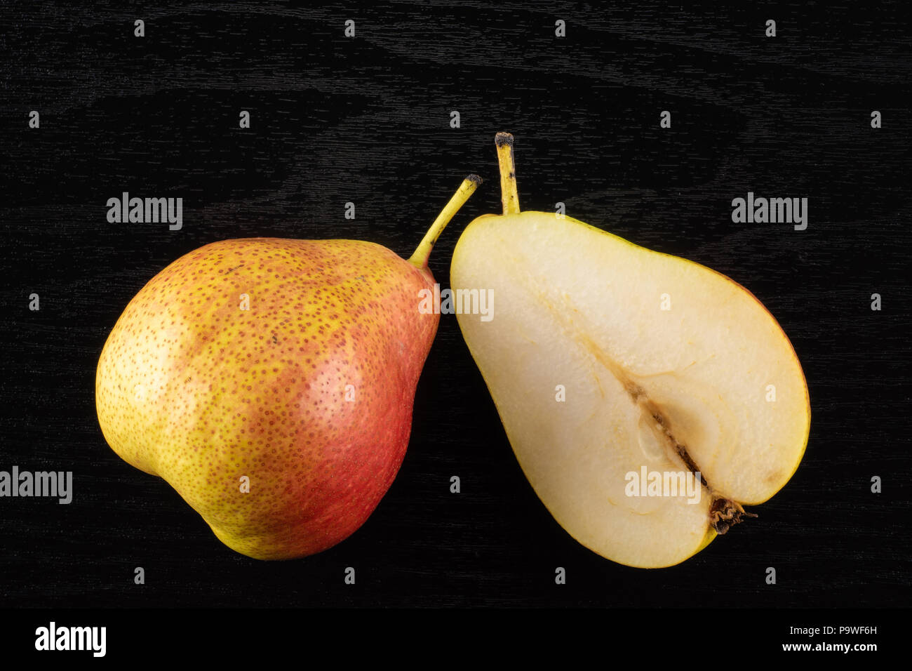 Group of one whole one half of fresh red pear forelle variety flatlay ...